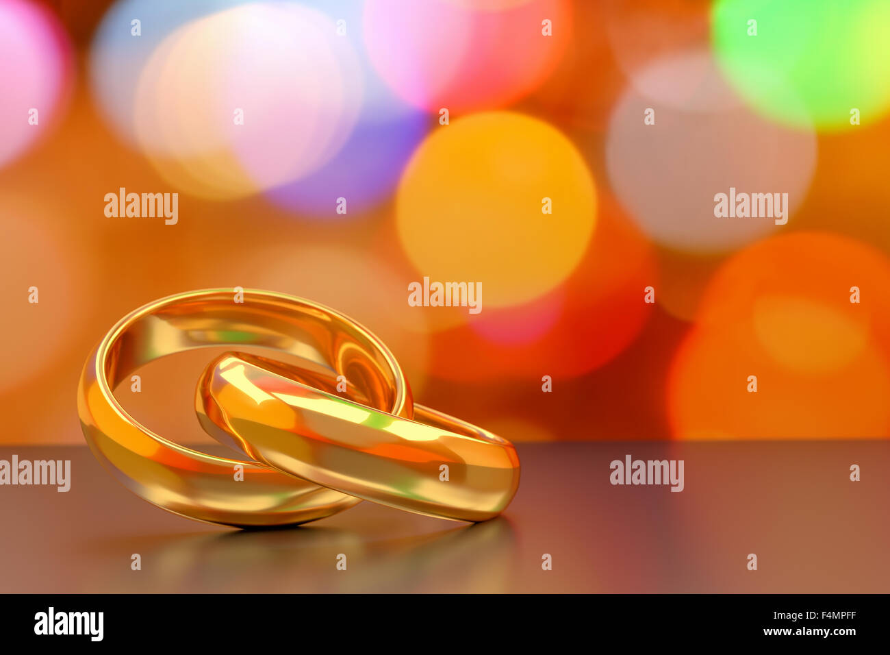 couple of gold wedding rings on bokeh background Stock Photo - Alamy