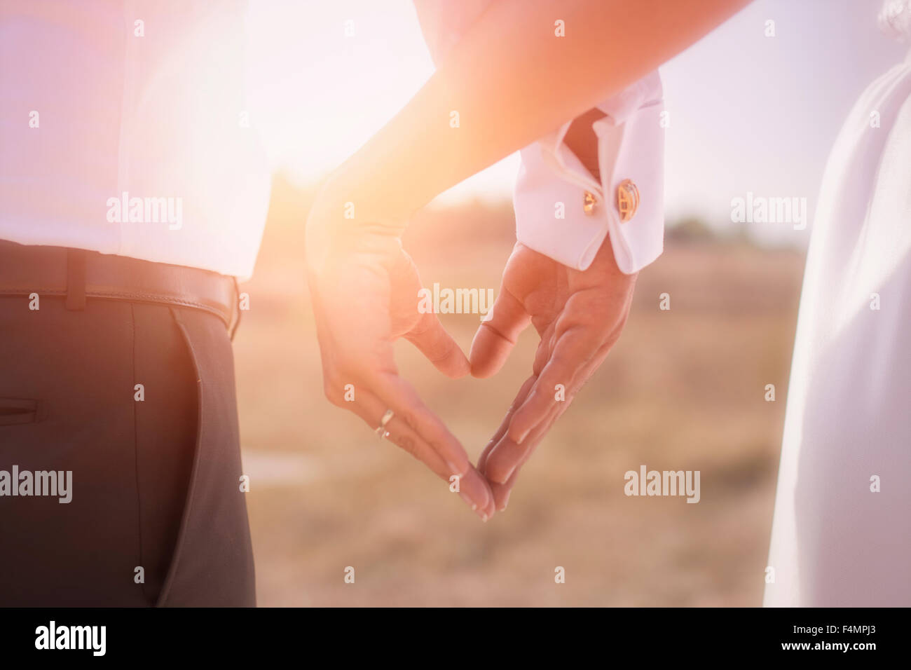 Holding Hands with wedding rings on the background of sunlight Stock ...