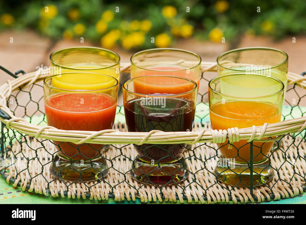 Tray with various fresh fruit juices in a garden setting Stock Photo ...