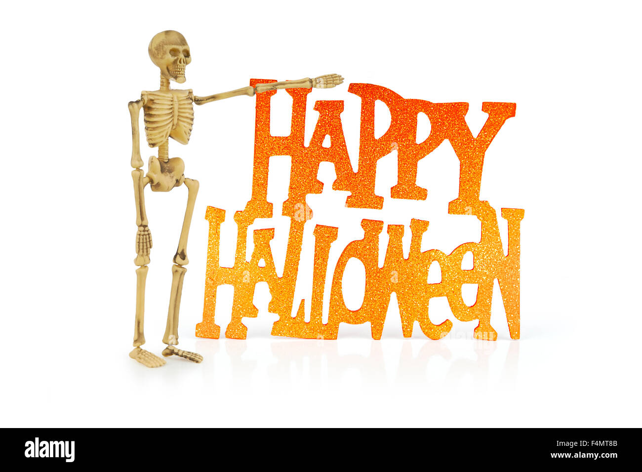 Halloween concept with a orange Happy Halloween sign and skeleton on a ...