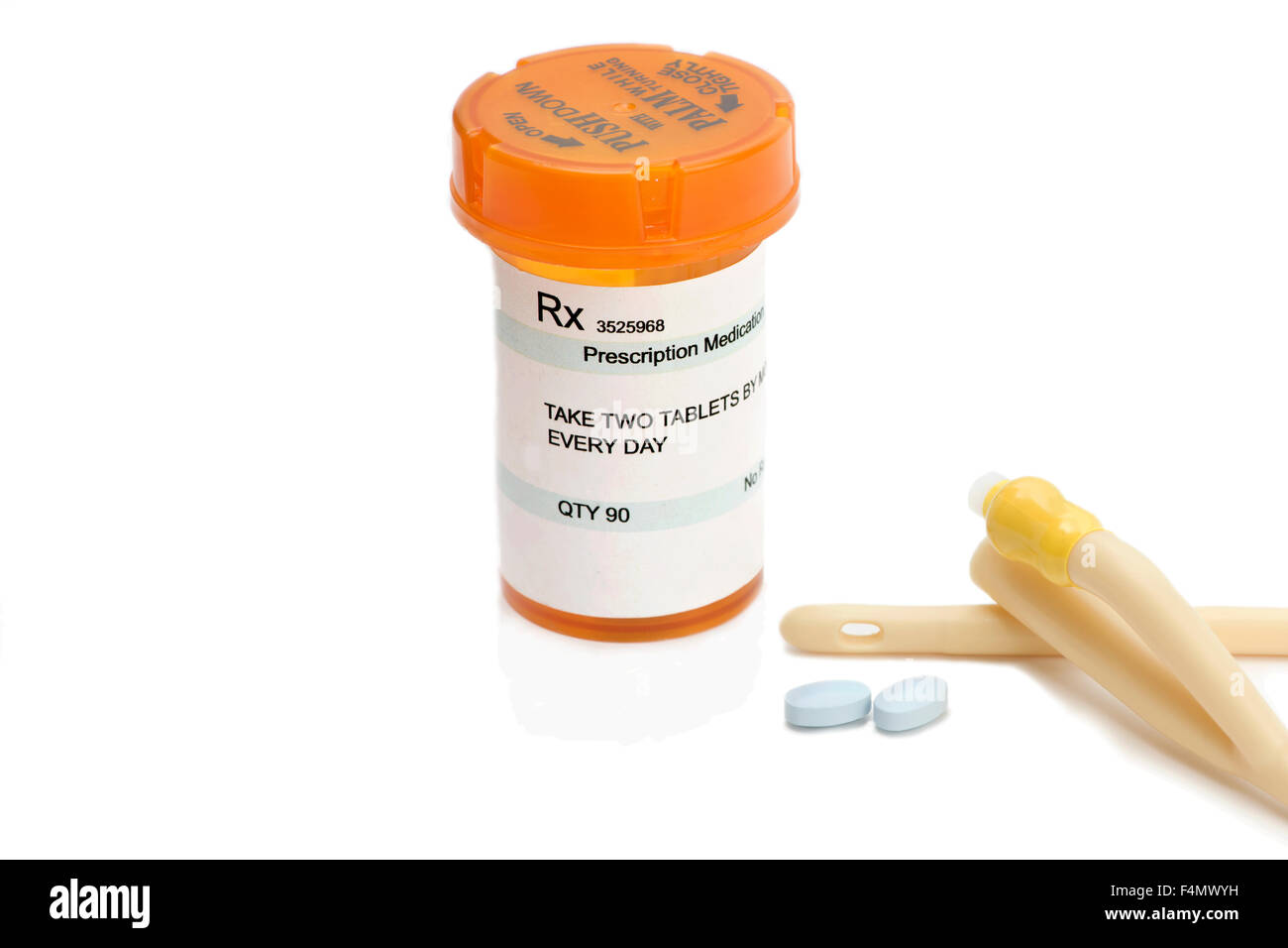 Prescription medication bottle with blue pills and catheter Stock Photo ...
