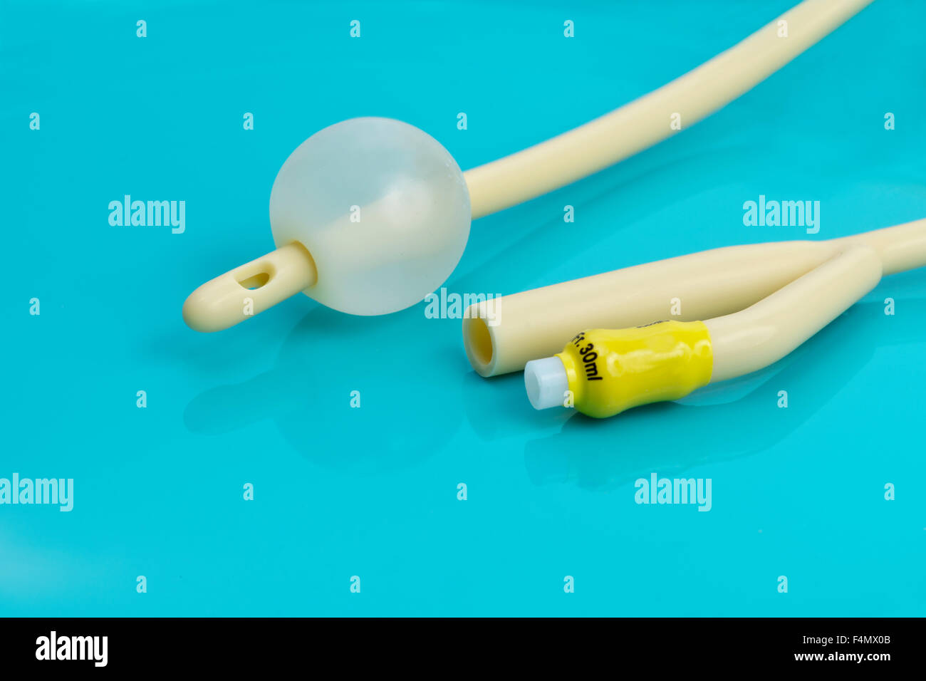 Close up of straight urinary catheter on aqua background Stock Photo ...