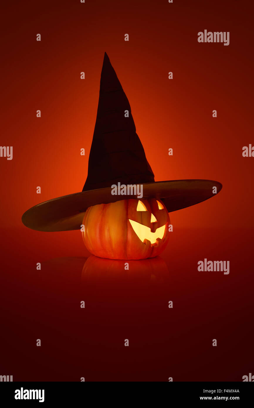 Halloween concept with a black Witches hat on a jack o lantern Pumpkin ...