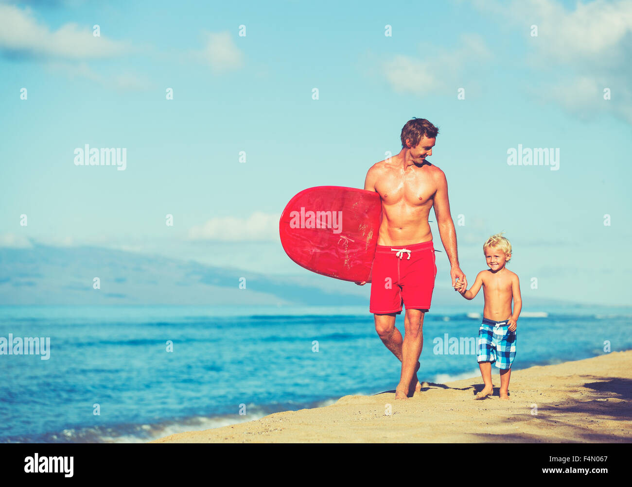Father and son going surfing together. Summer fun outdoor lifestyle ...