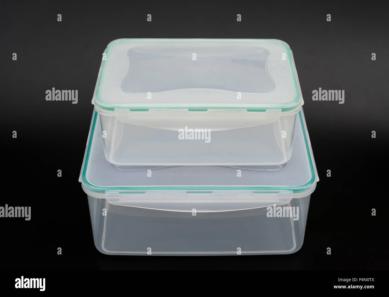 translucent storage boxes stack up on a black background Stock Photo ...