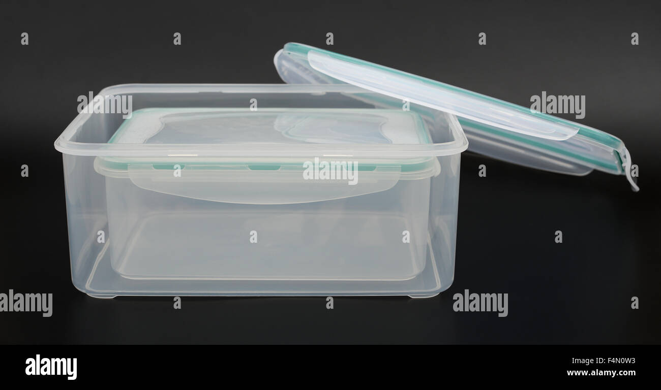 translucent storage boxes with lip opened on a black background Stock ...