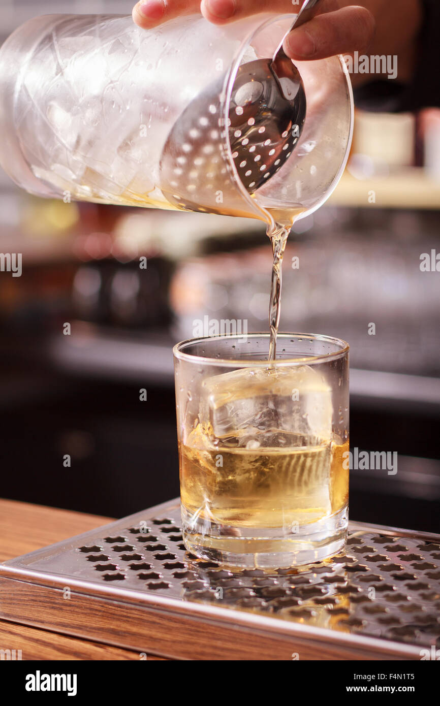 Bartender making cocktail on a Bar Stock Photo - Alamy