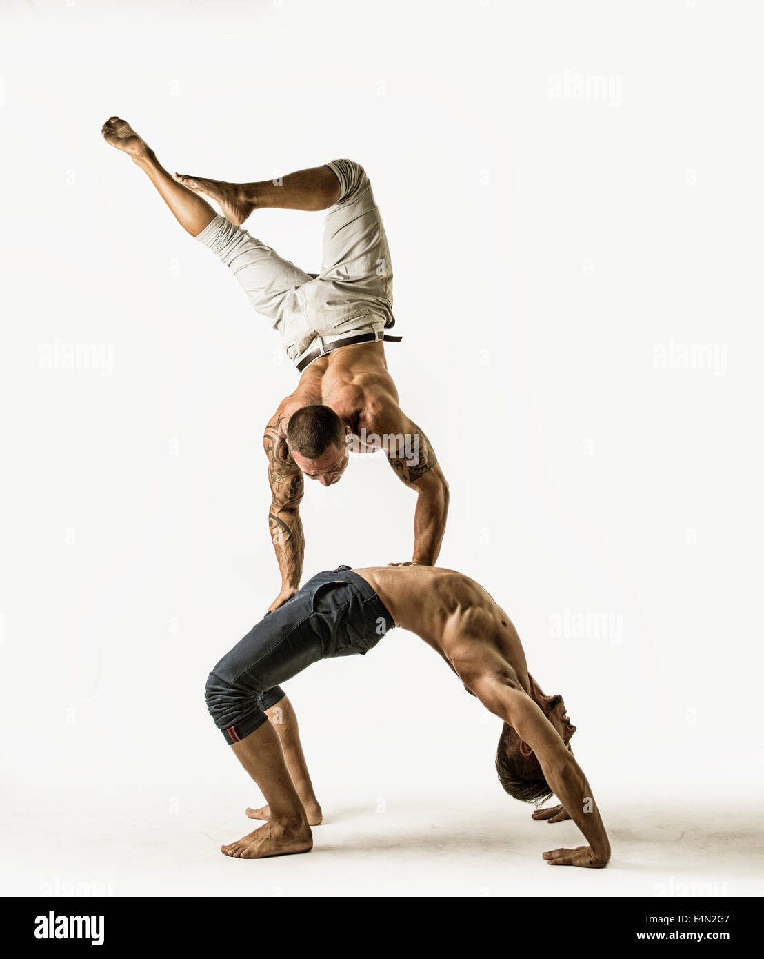 Muscular Shirtless Male Acrobatic Dancers Balancing on Top of Each ...