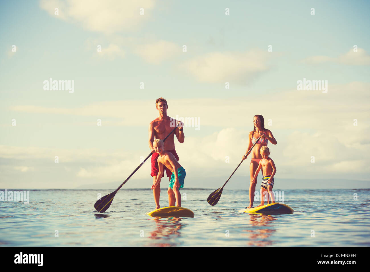 Family stand up paddling at sunrise, Summer fun outdoor lifestyle Stock ...