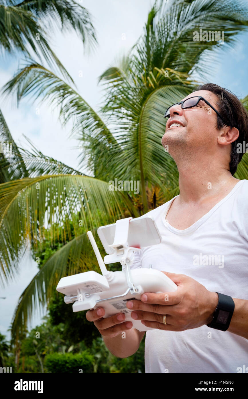 Man flying drone with remote control Stock Photo - Alamy