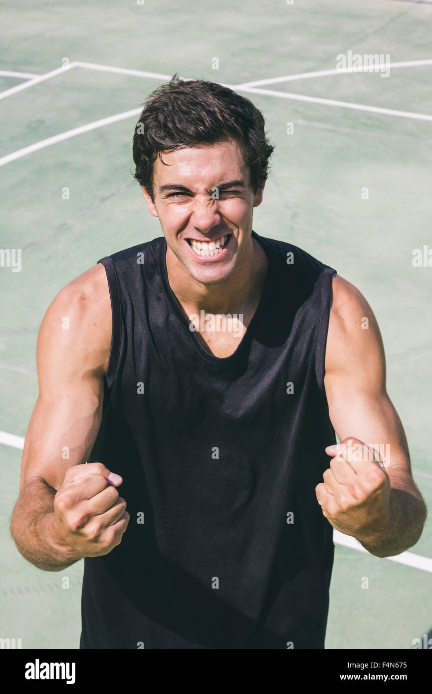 Young basketball player clenching teeth and fists Stock Photo - Alamy