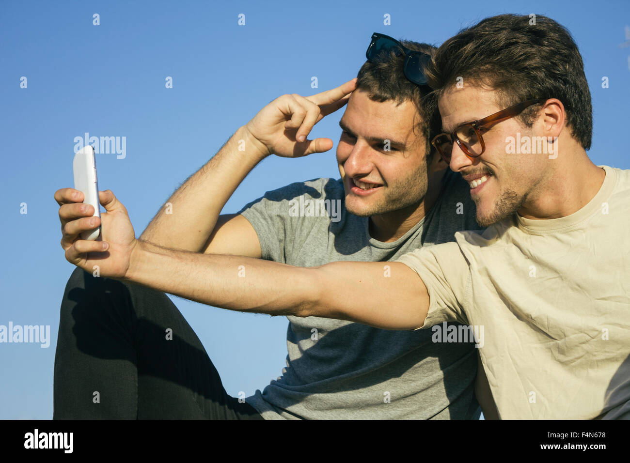 Two friends taking a selfie with smartphone Stock Photo - Alamy