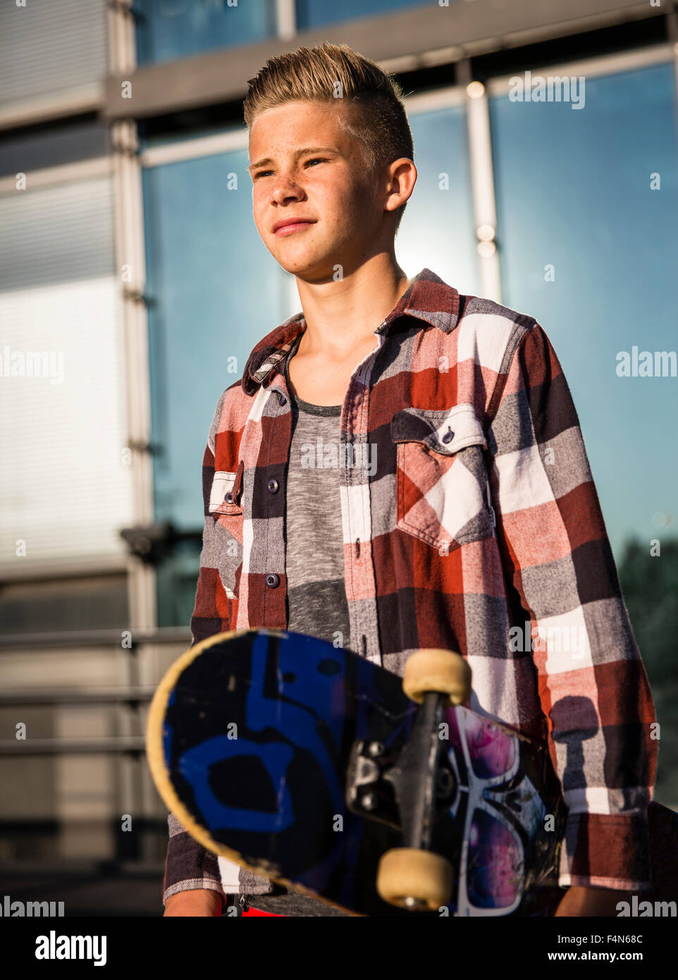 Confident teenager holding skateboard Stock Photo - Alamy Confident teenager holding skateboard Stock Photo - Alamy
