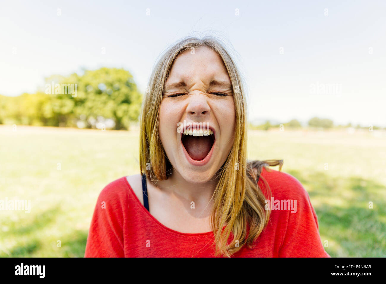 Portrait of teenage girl outdoors screaming Stock Photo - Alamy