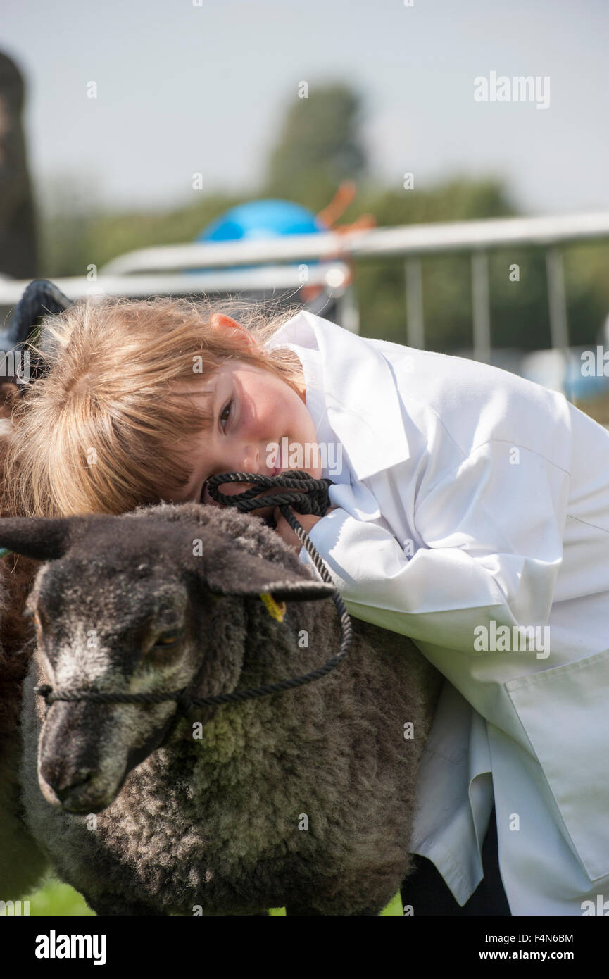 Young girl giving her sheep a hug at Westmorland County Show, Cumbria ...
