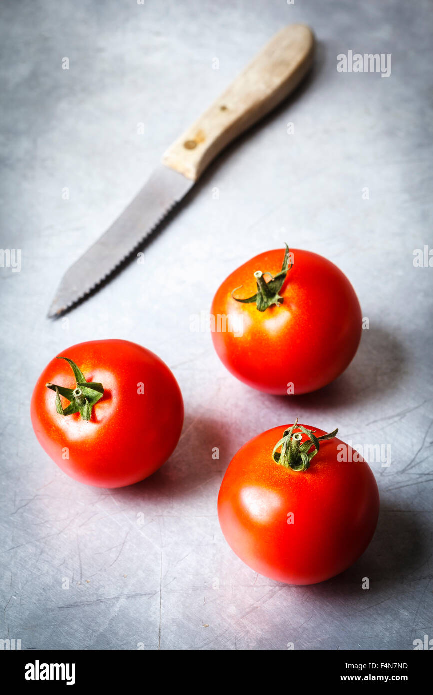 Red tomatoes, Devotion, kitchen knife Stock Photo - Alamy