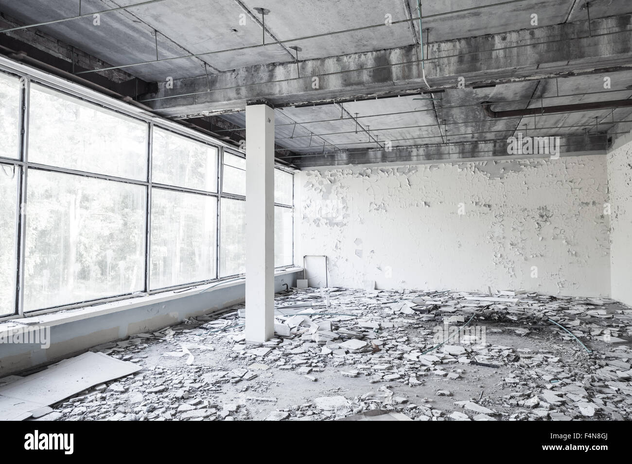 Abandoned industrial building interior. Concrete walls and broken windows Stock Photo - Alamy