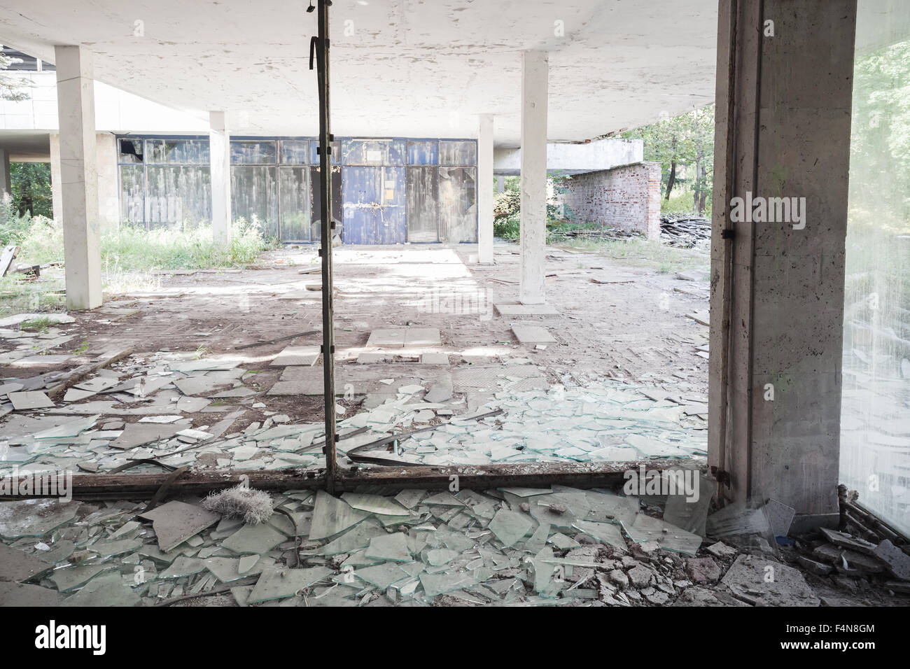 Abandoned industrial building interior. Concrete columns and broken ...