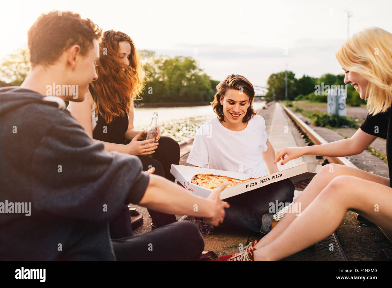 Four Friends Sharing Pizza High Resolution Stock Photography and Images ...