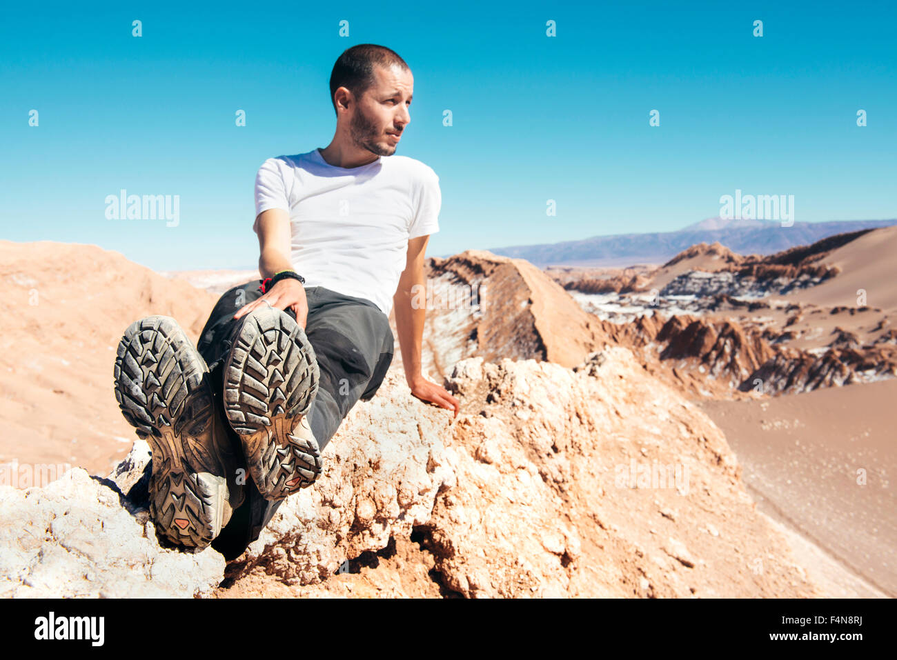 Chile, Atacama Desert, man sitting on a mountain crest Stock Photo - Alamy