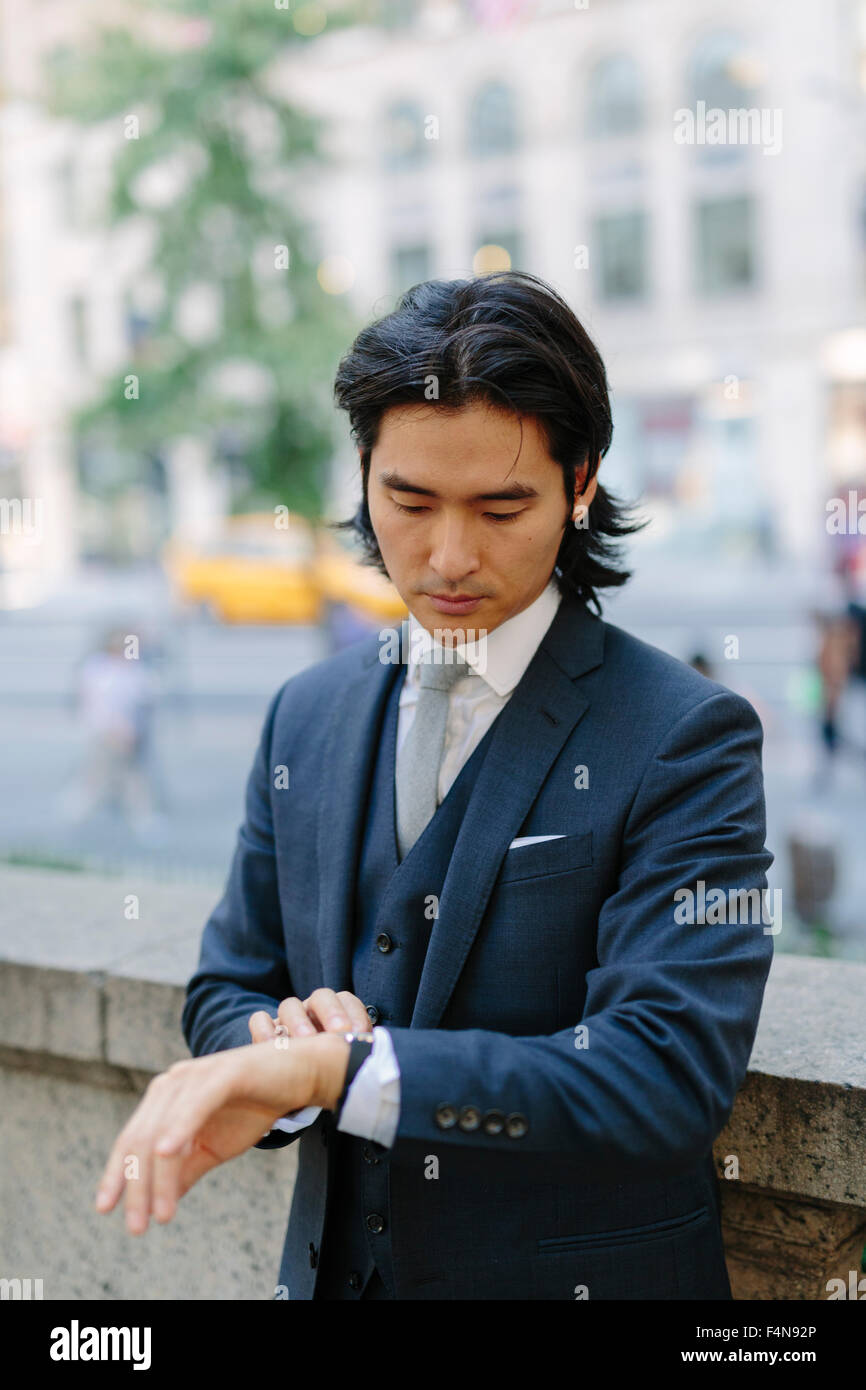 USA, New York City, businessman checking the time Stock Photo - Alamy