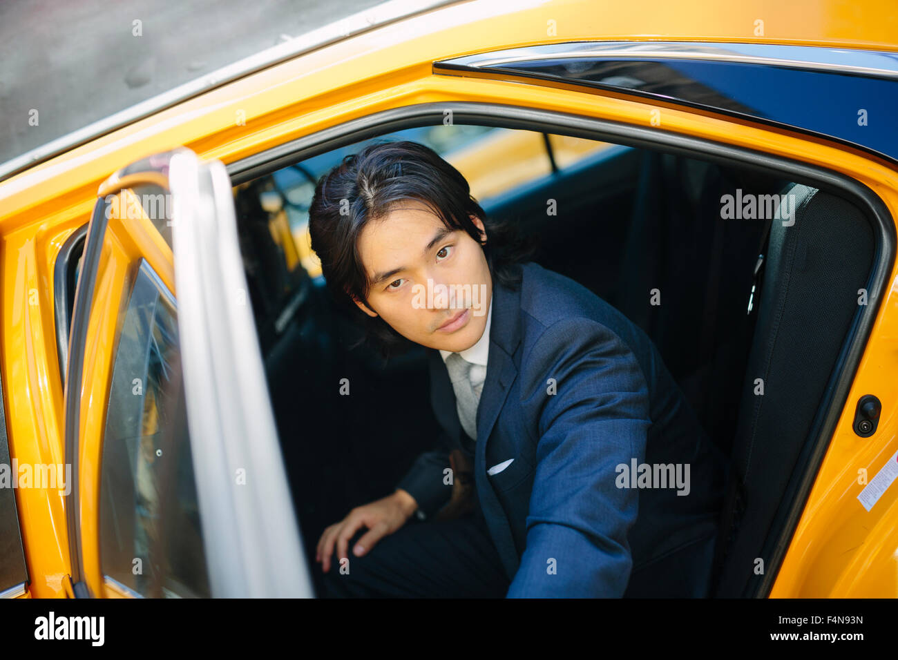 USA, New York City, portrait of businessman entering a taxi Stock Photo ...