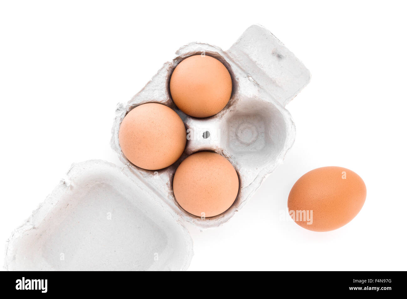 Four eggs in a cardboard egg carton Stock Photo - Alamy