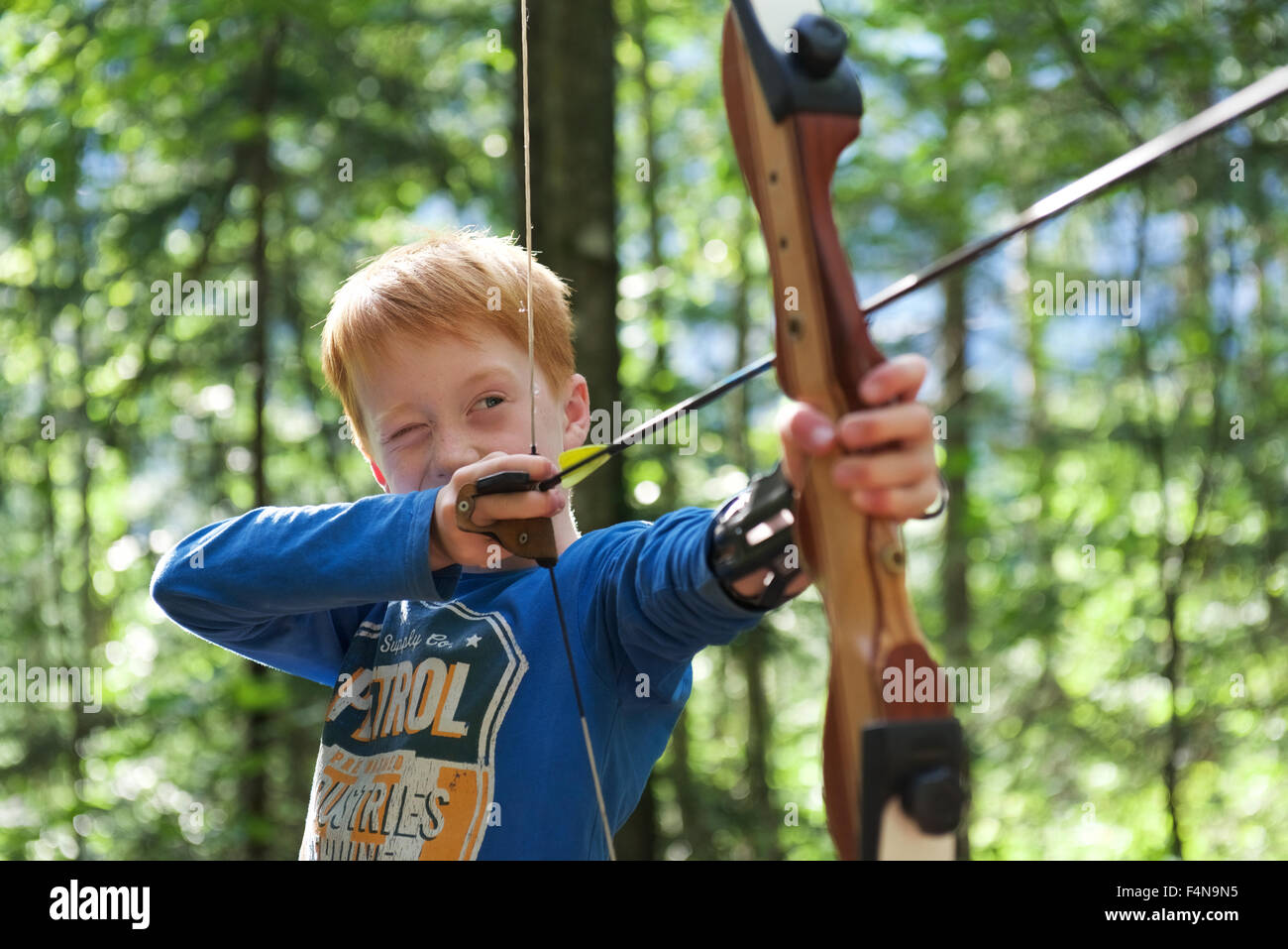 Portrait of a boy with bow and arrow in an adventure park Stock Photo ...