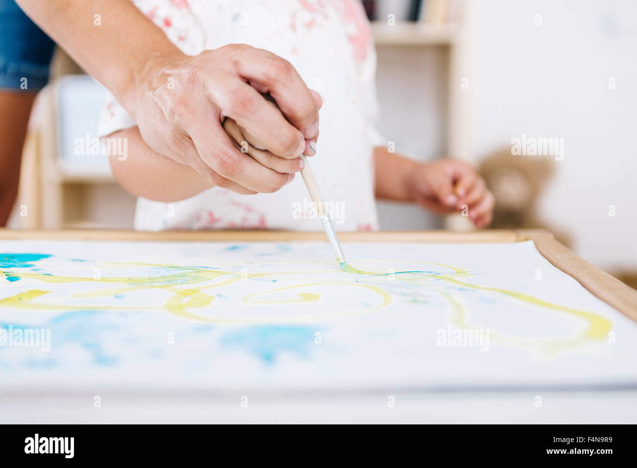 Woman helping little boy to paint with watercolours, close-up Stock ...