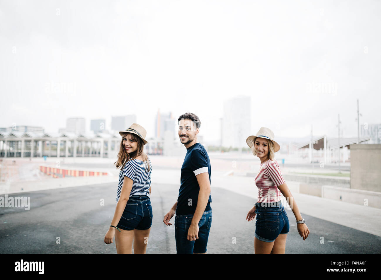 Spain, Barcelona, portrait of three friends looking over their ...