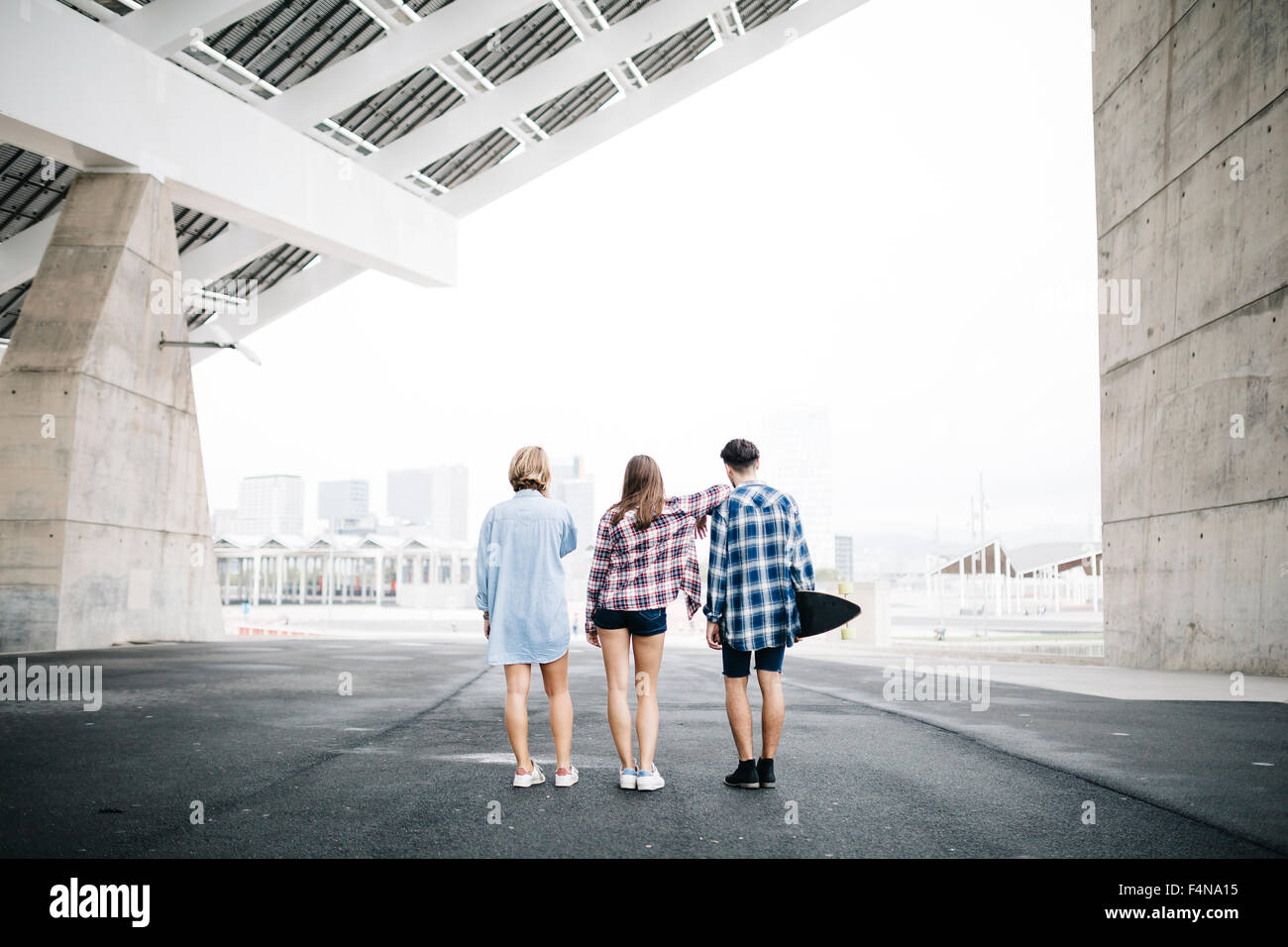 Three friends longboarding in the city Stock Photo - Alamy