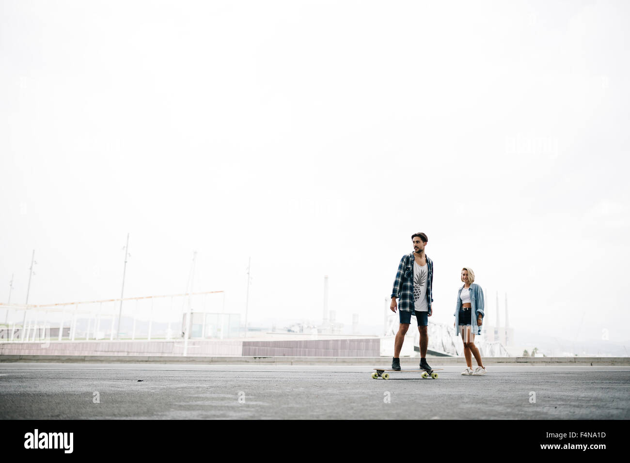 Friends longboarding in the street Stock Photo - Alamy