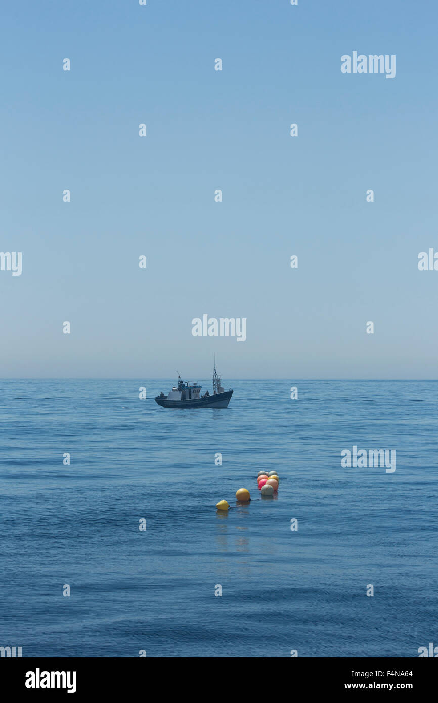 Spain, Strait of Gibraltar, Fishing boat and buoys Stock Photo - Alamy