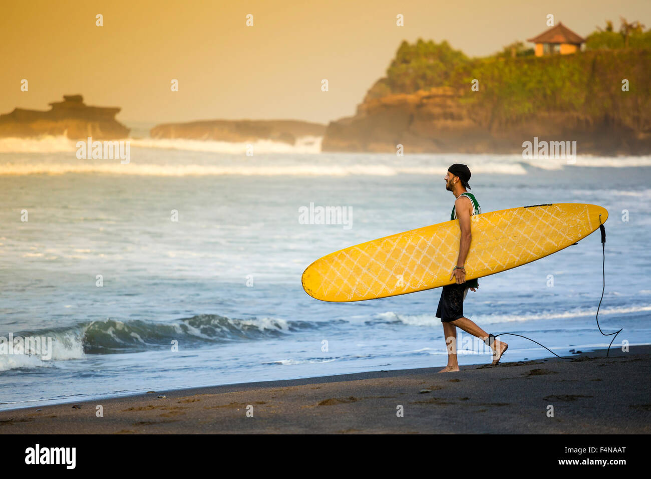 Indonesia, Bali, surfer walking on the beach Stock Photo - Alamy