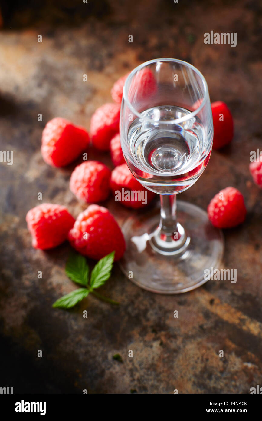 Raspberries and glass of raspberry brandy Stock Photo - Alamy