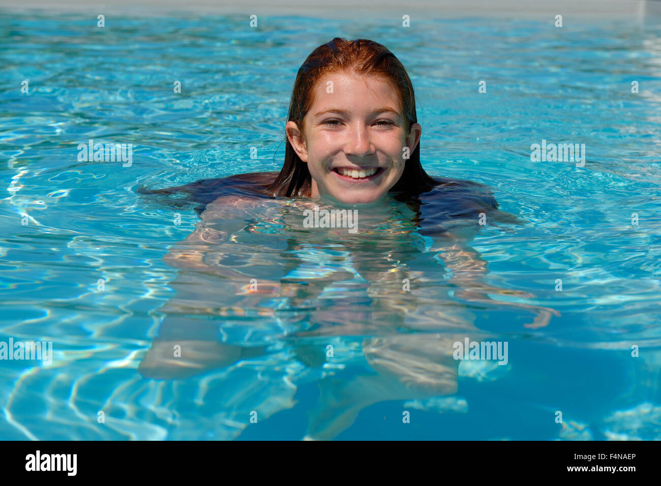 Portrait of smiling girl in swimming pool Stock Photo - Alamy