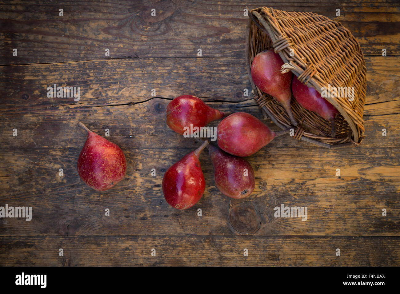 Wickerbasket and organic red Clapp's Favourite on dark wood Stock Photo ...