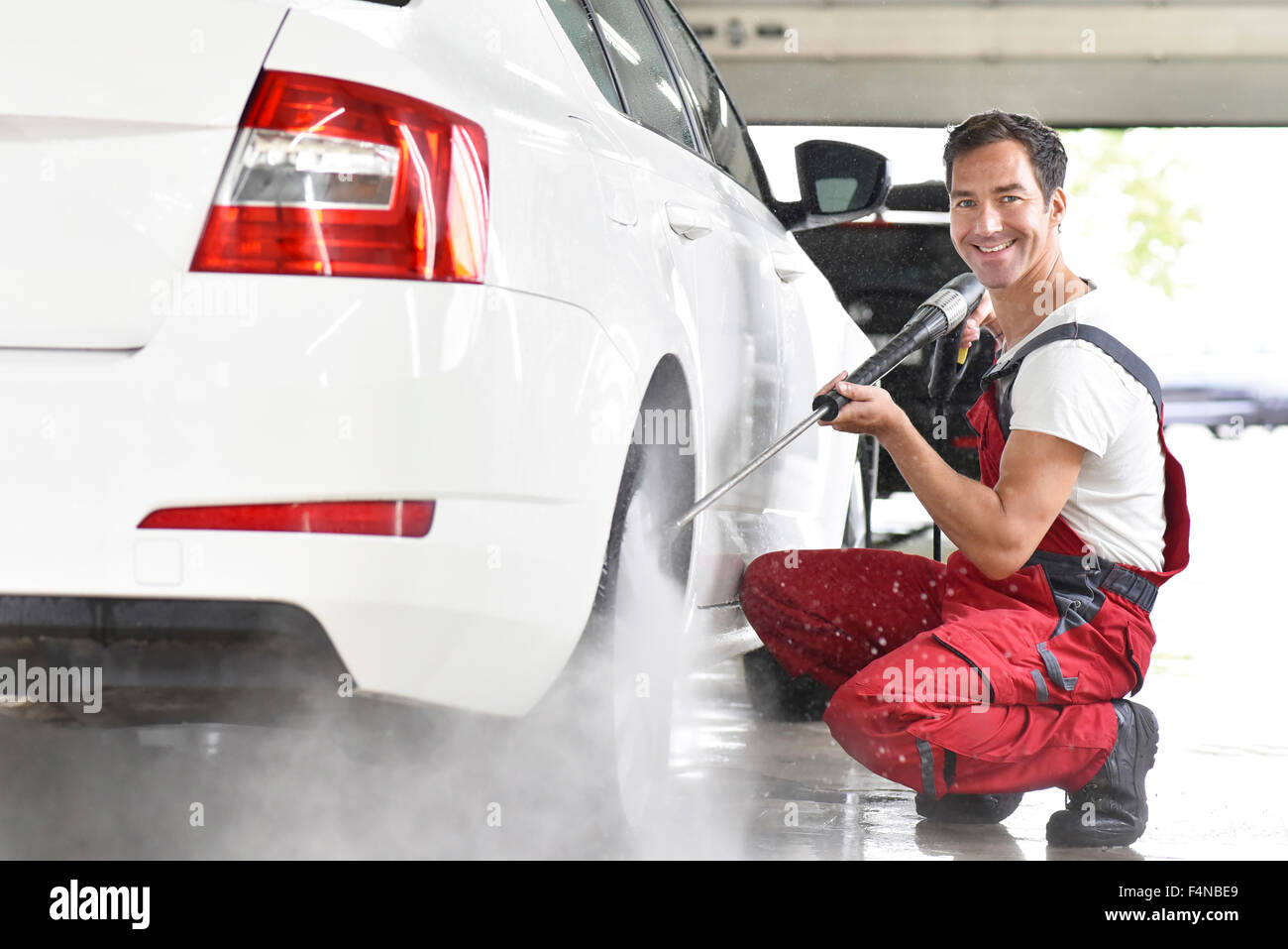 Car cleaning, man cleaning car with high-pressure cleaner Stock Photo ...
