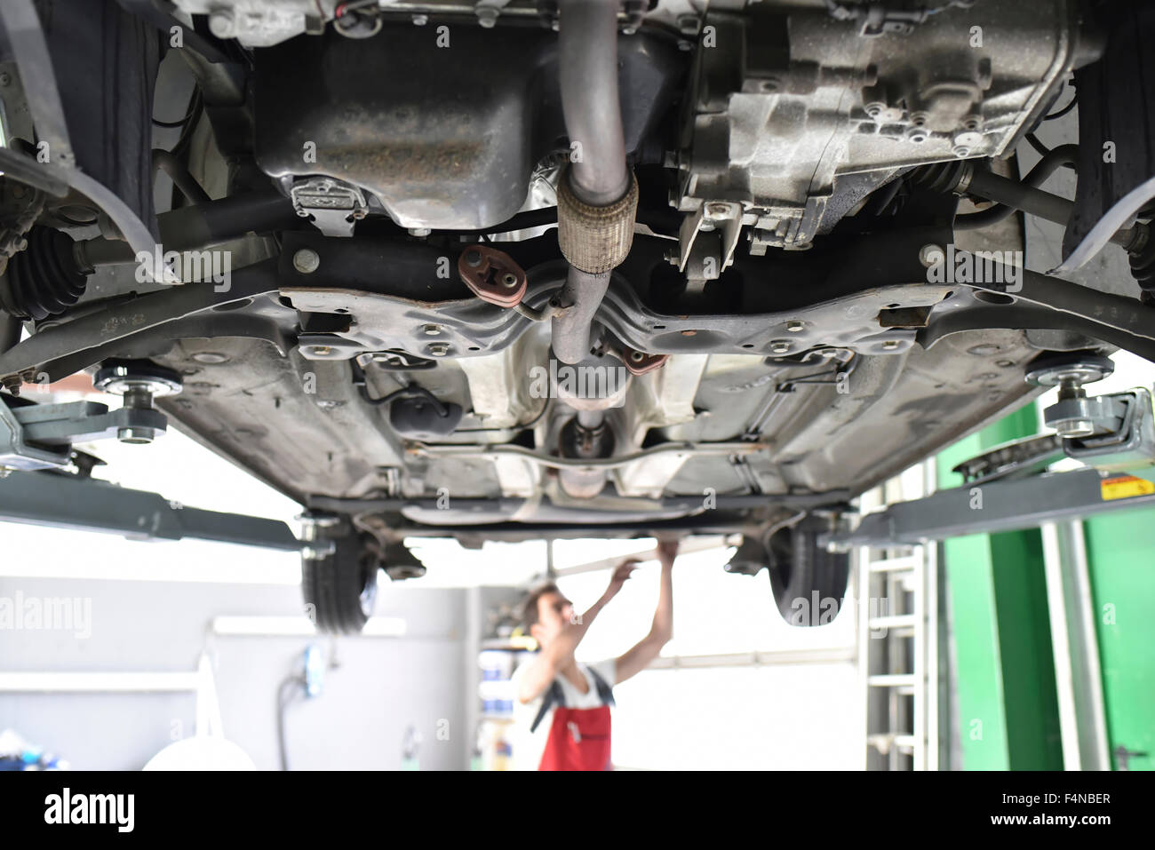 Mechanic repairing underbody car in hi-res stock photography and images ...
