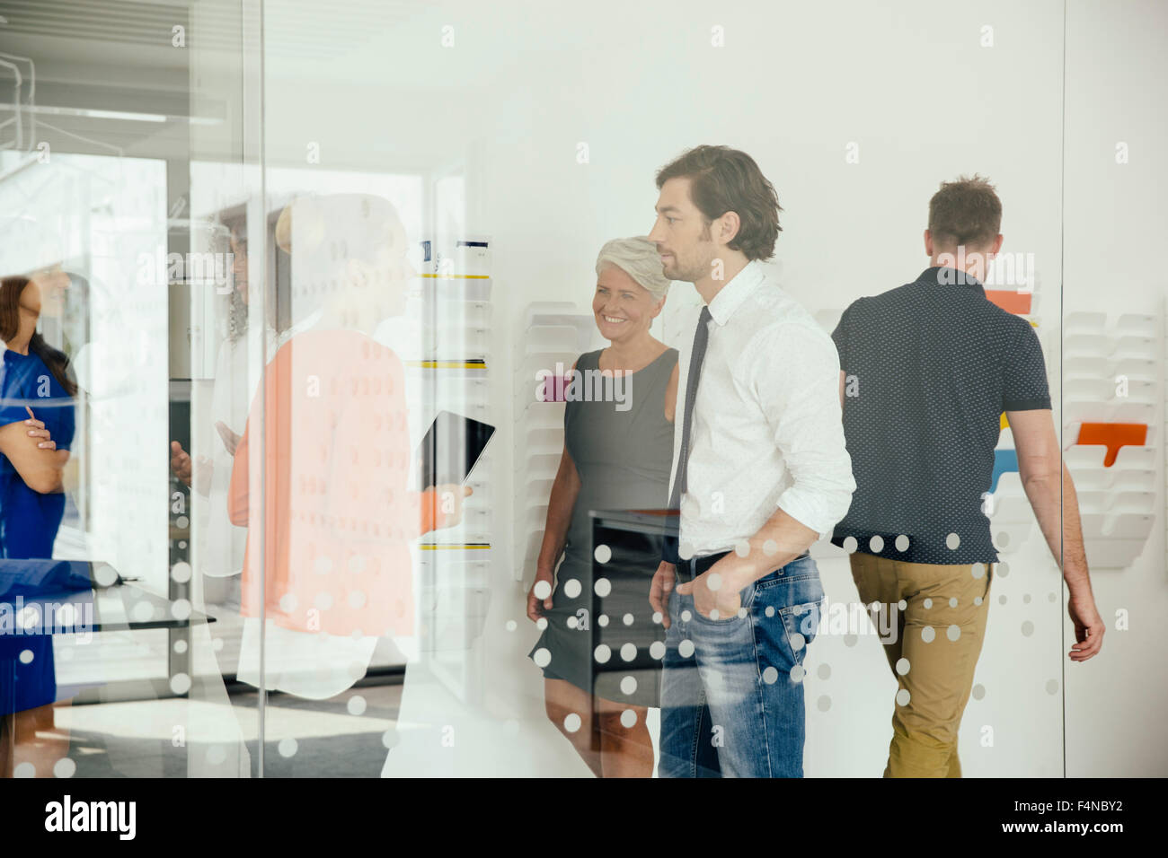 Employees in a modern office walking around Stock Photo - Alamy