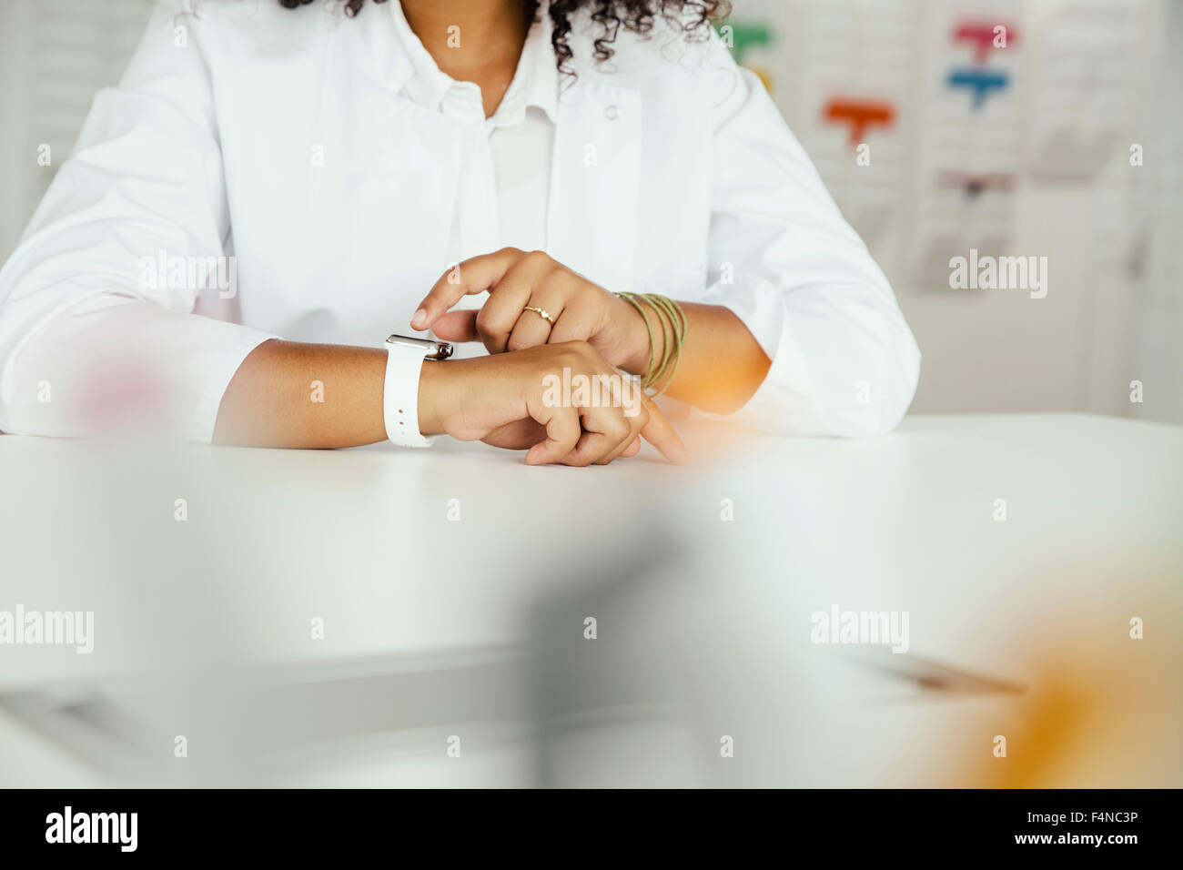 Scientist in lab using smartwatch Stock Photo - Alamy