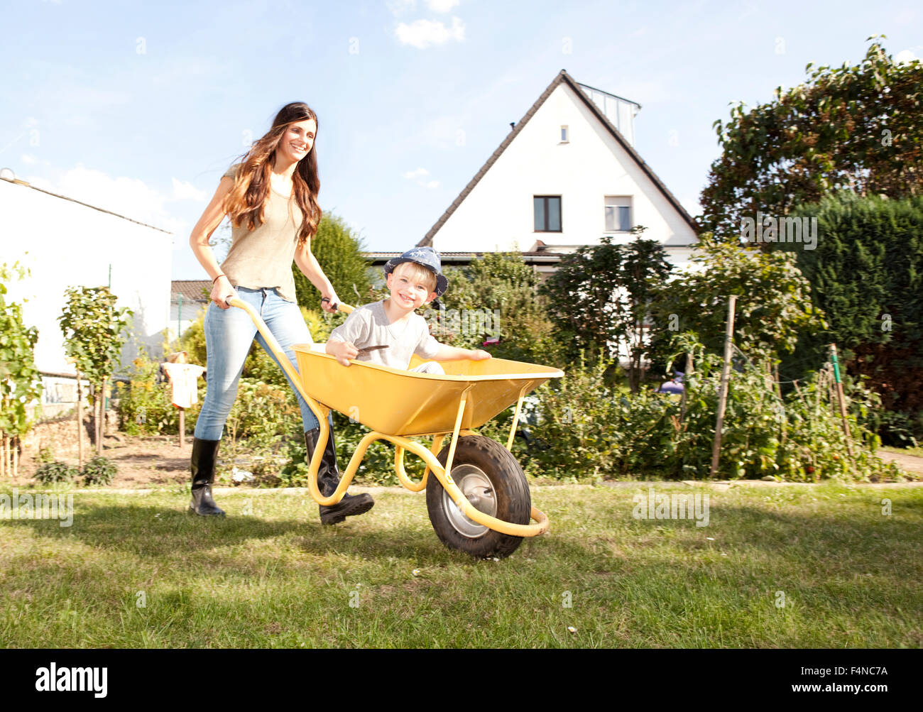 Woman Pushing A Wheelbarrow High Resolution Stock Photography and ...