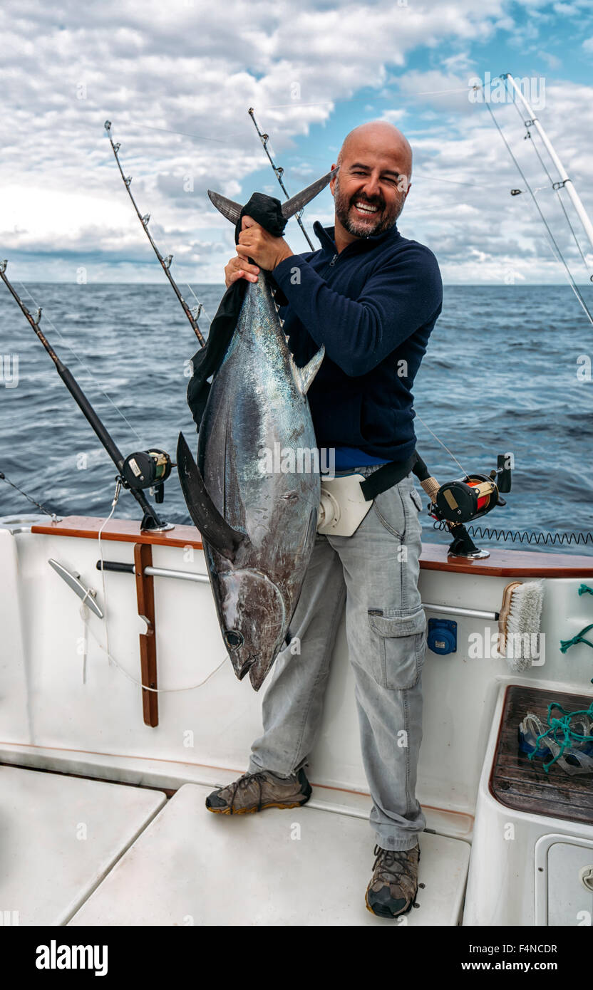 Spain, Asturias, Fisherman holding freshly caught tuna Stock Photo - Alamy