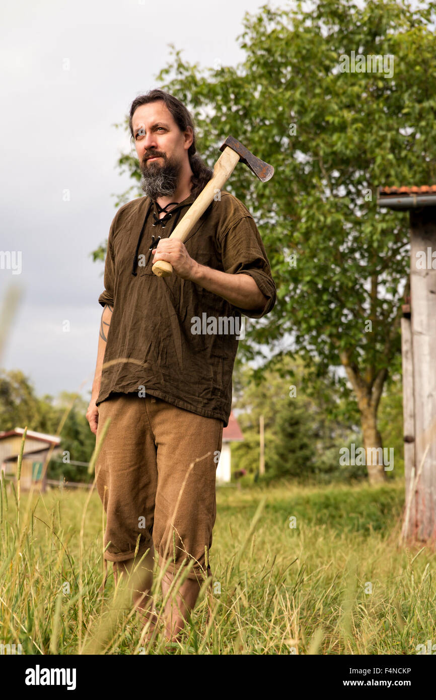 Man with axe standing in the country Stock Photo - Alamy
