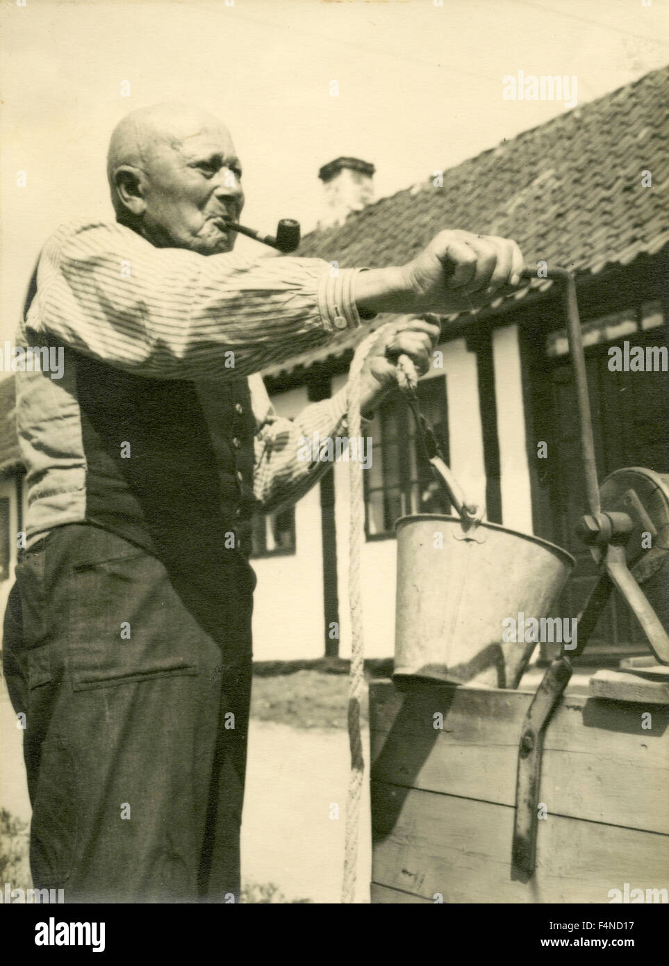 Bald old man takes the water from a well hi-res stock photography and ...