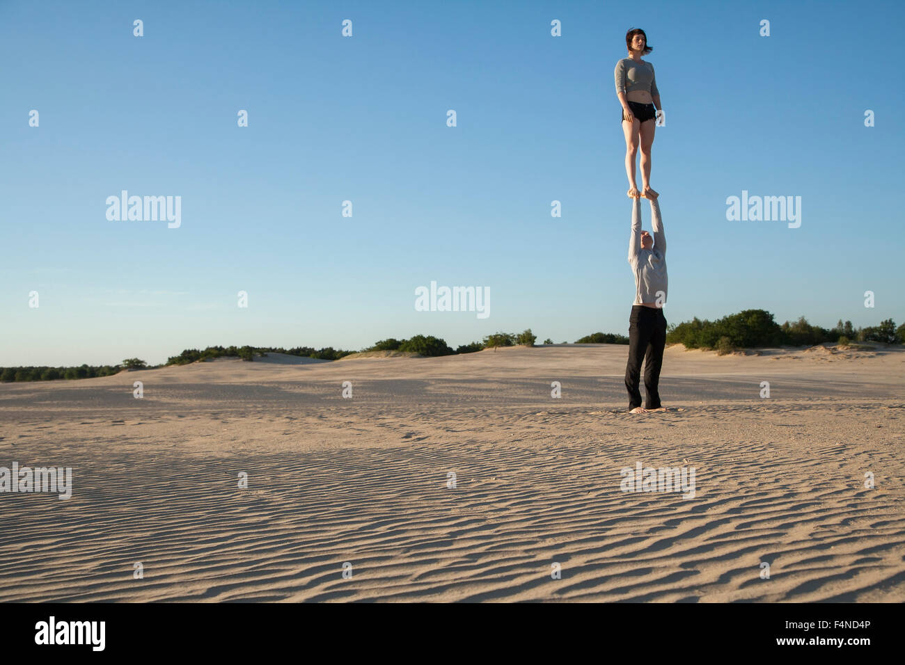 Netherlands, Acrobat couple performing foot to hand balance Stock Photo ...