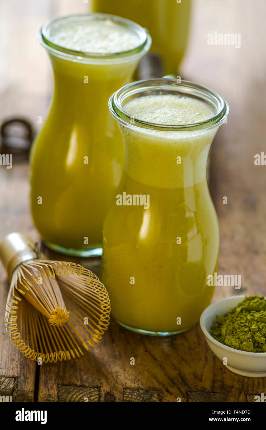 Two glass bottles of matcha smoothie Stock Photo - Alamy