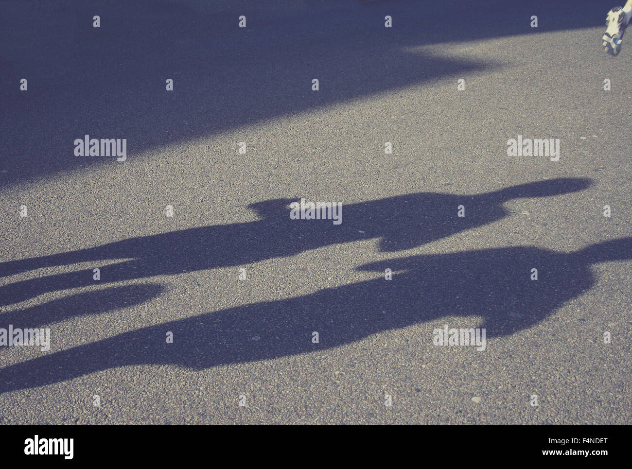 Shadows of runners on asphalt during a run Stock Photo - Alamy