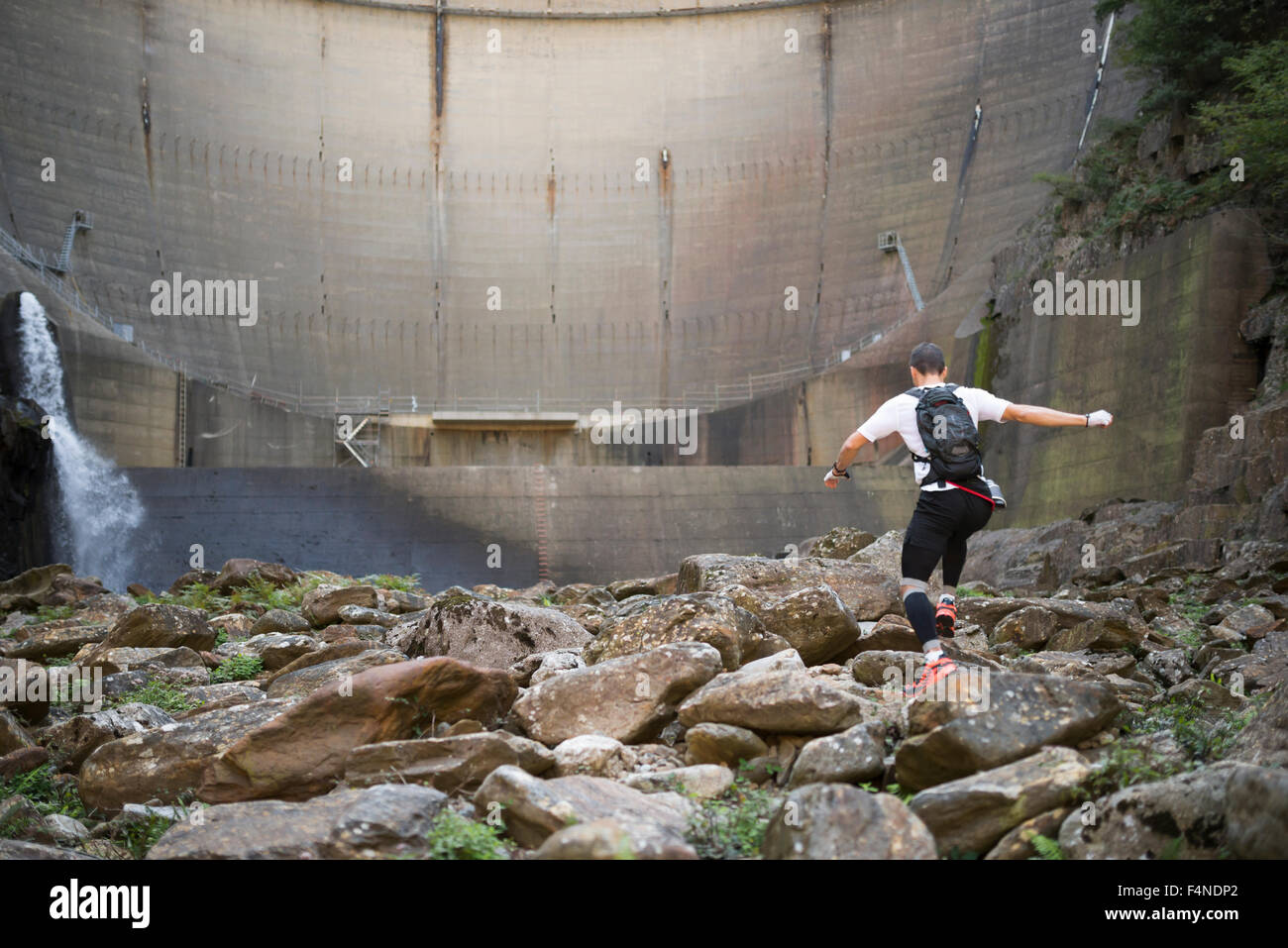 Young man running on the rocks hi-res stock photography and images - Alamy