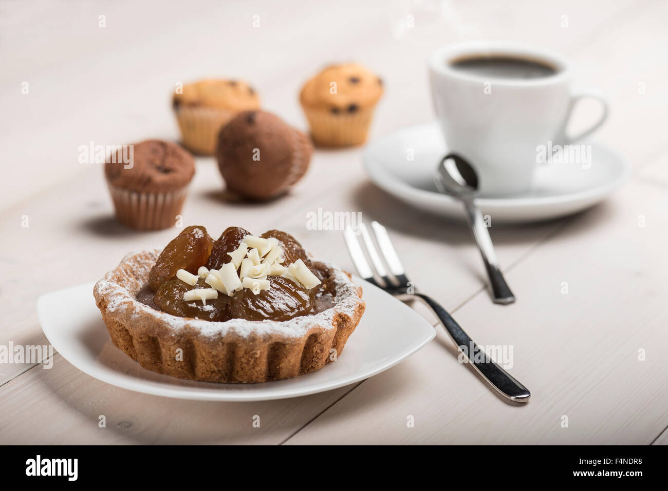 chestnut cake decorated with white chocolate and cup of coffee on ...